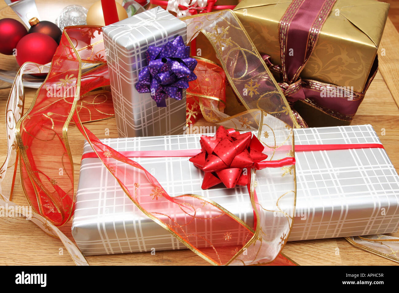 christmas present on a solid oak table ribbons and decorations around ...