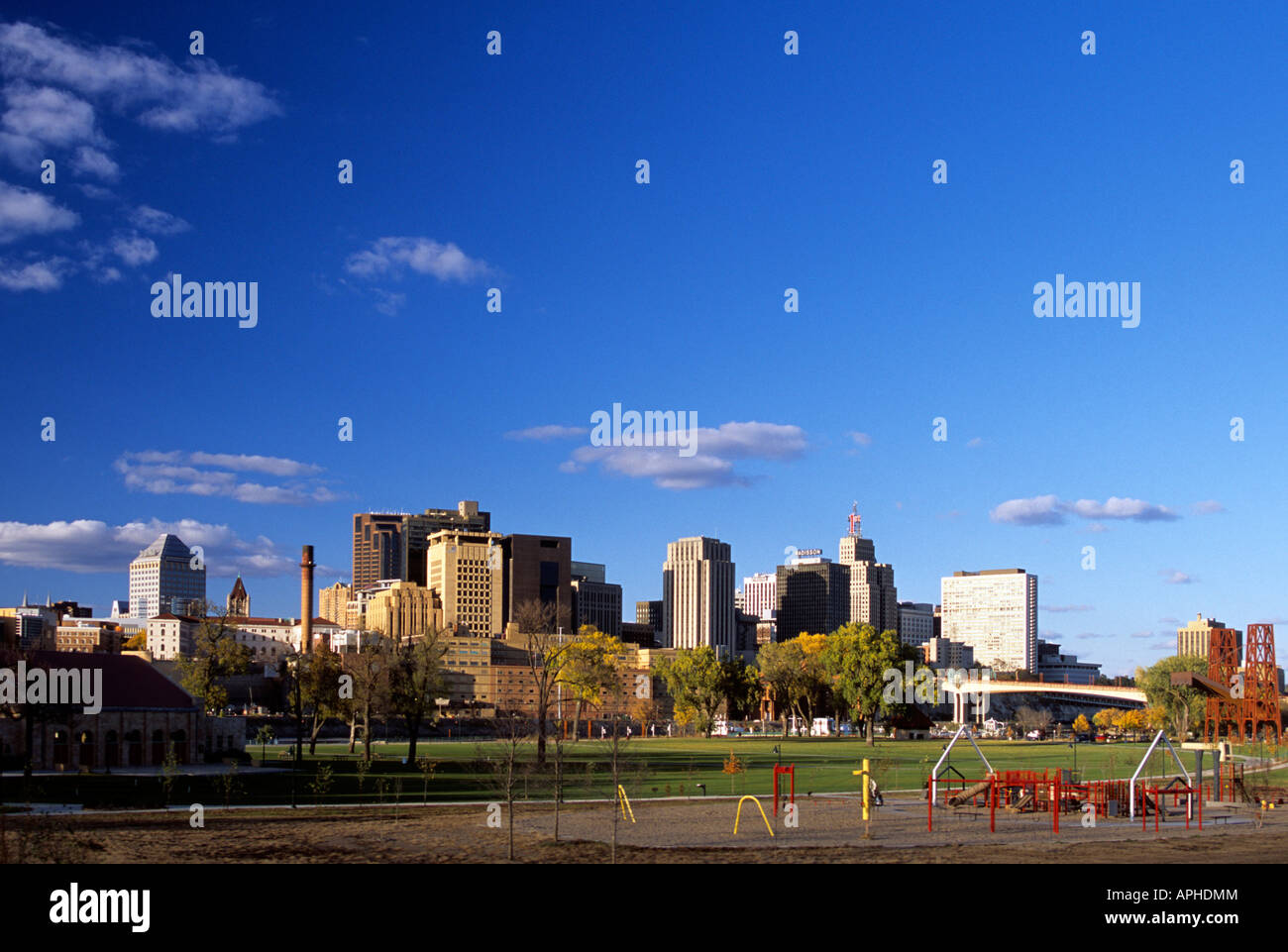 PLAYGROUND IN HARRIET ISLAND PARK ON THE MISSISSIPPI RIVER. SKYLINE OF ...