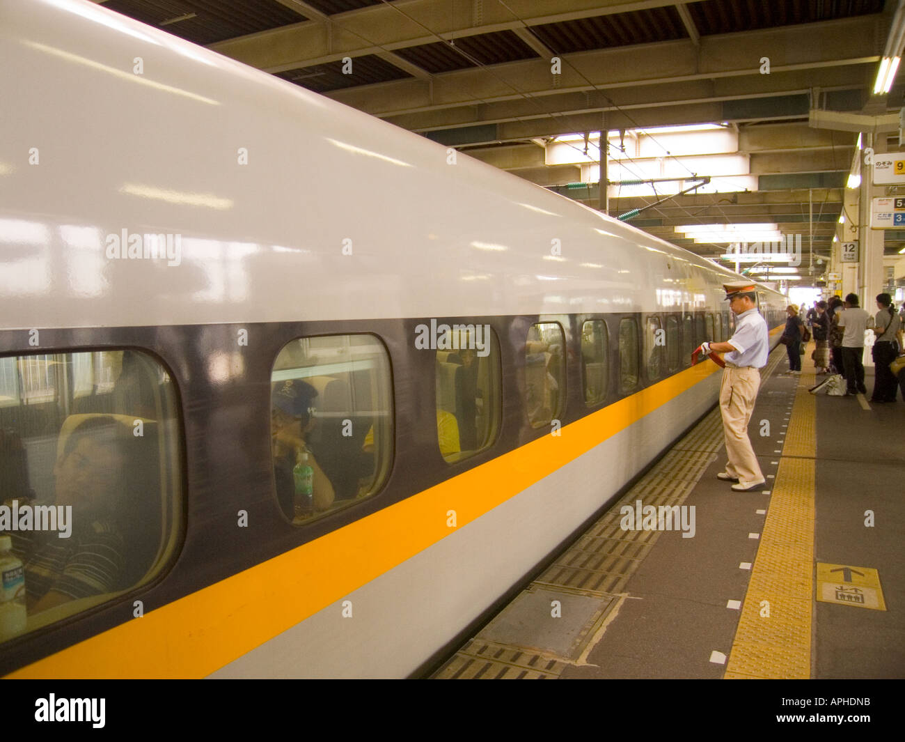 japan kyoto bullet train in station with train attendant on platform ...