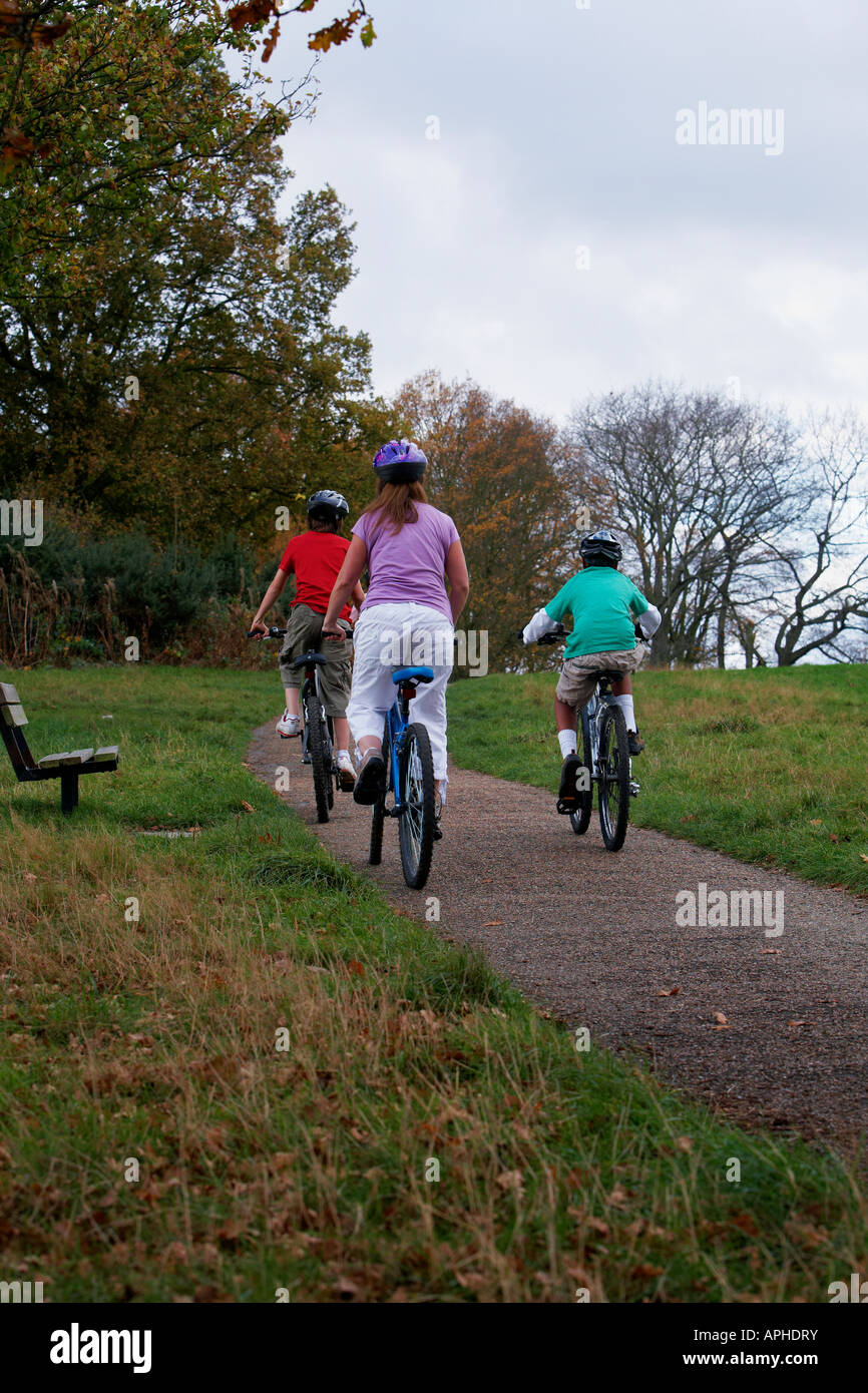 A group of children ride a bike along the path Stock Photo - Alamy