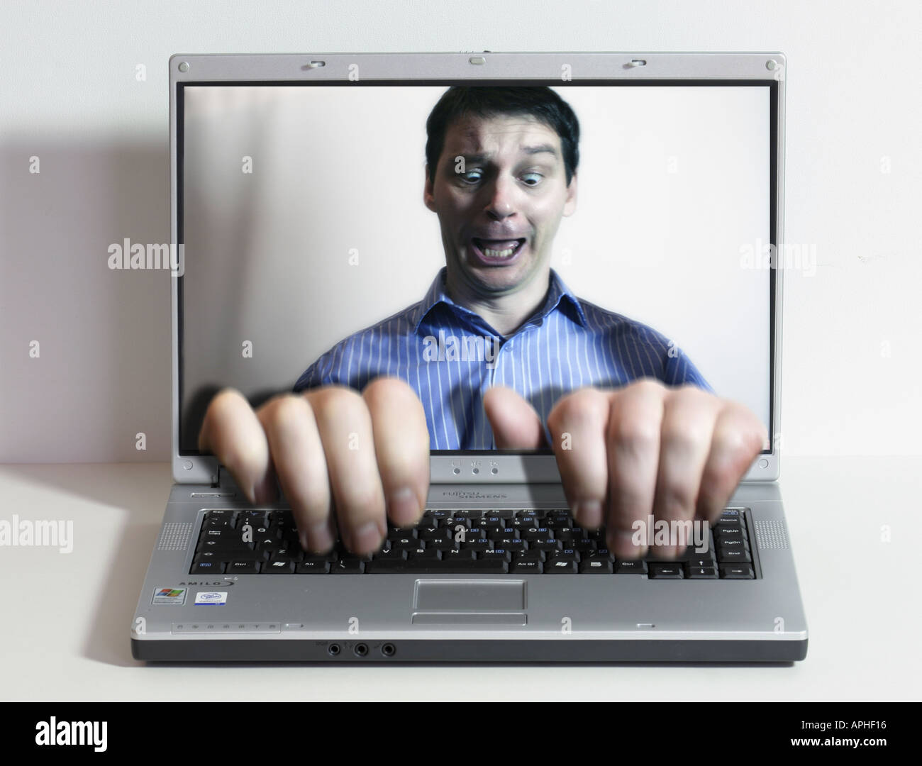 Man inside a laptop reaches out and types on the keyboard Stock Photo ...