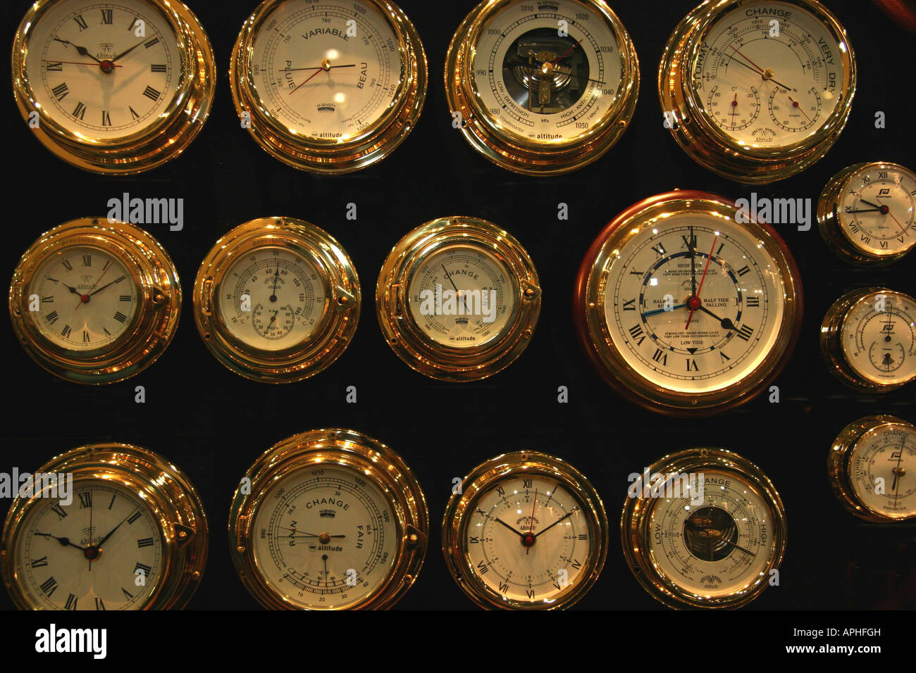 a selection of round brass clocks and dials for boat Stock Photo - Alamy