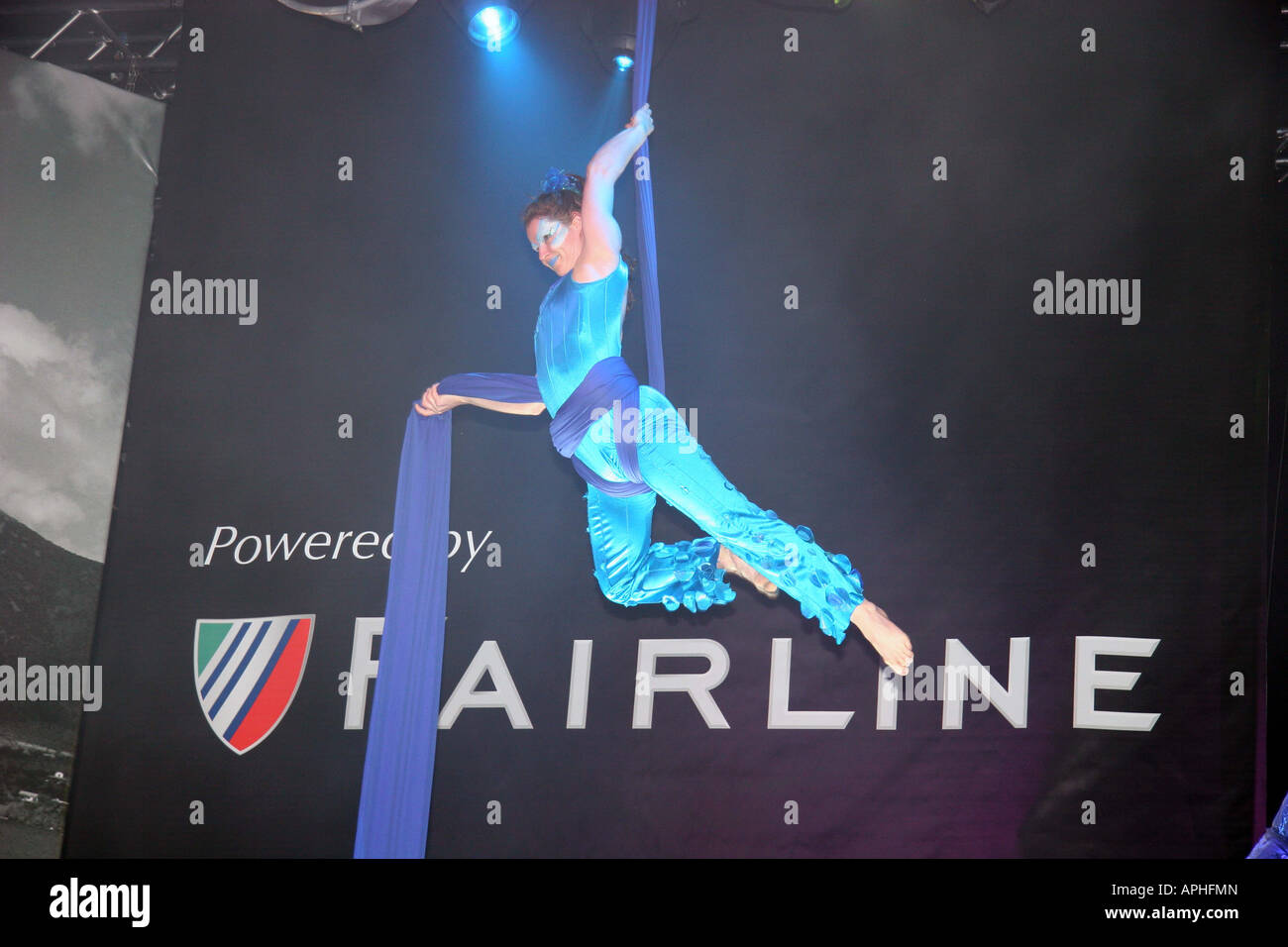 Aerial flyers slide on silk ropes on the main stage powered by Fairline ...