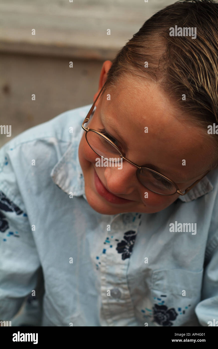 young boy sitting outside a house Stock Photo - Alamy