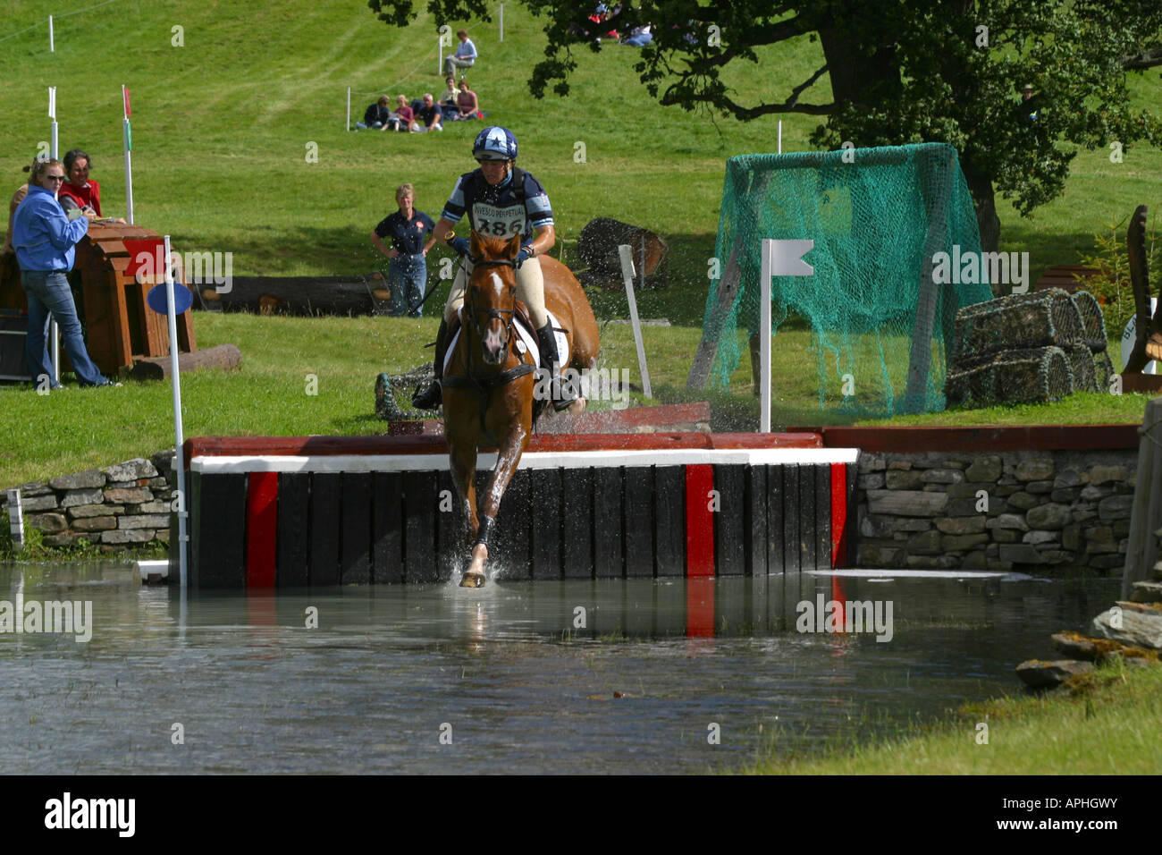 Cross country rider taking jump Stock Photo - Alamy