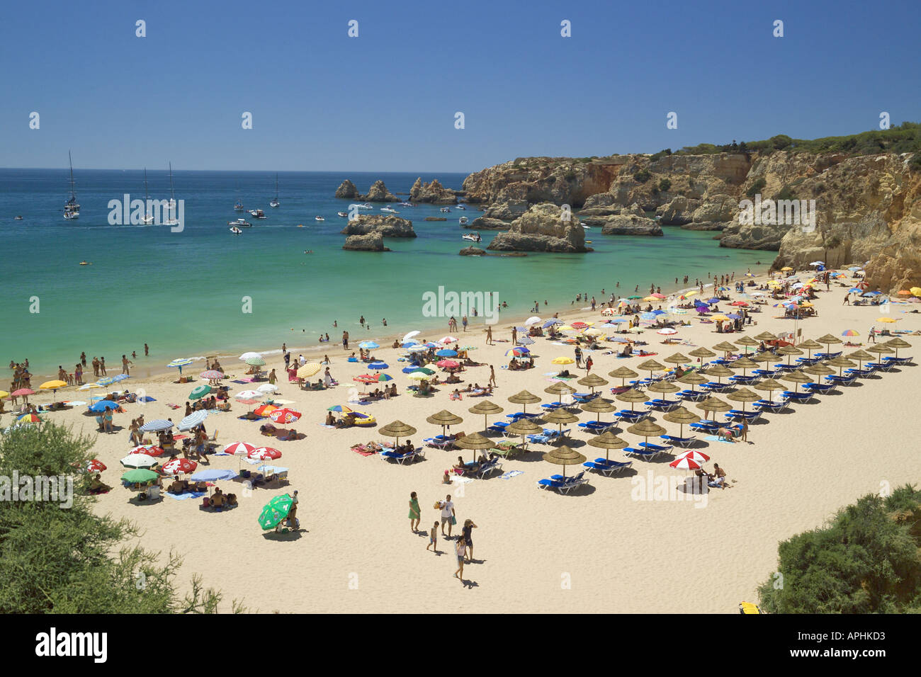 Portugal the Algarve Praia de Vau in summer, sunshades, beach and rocks ...