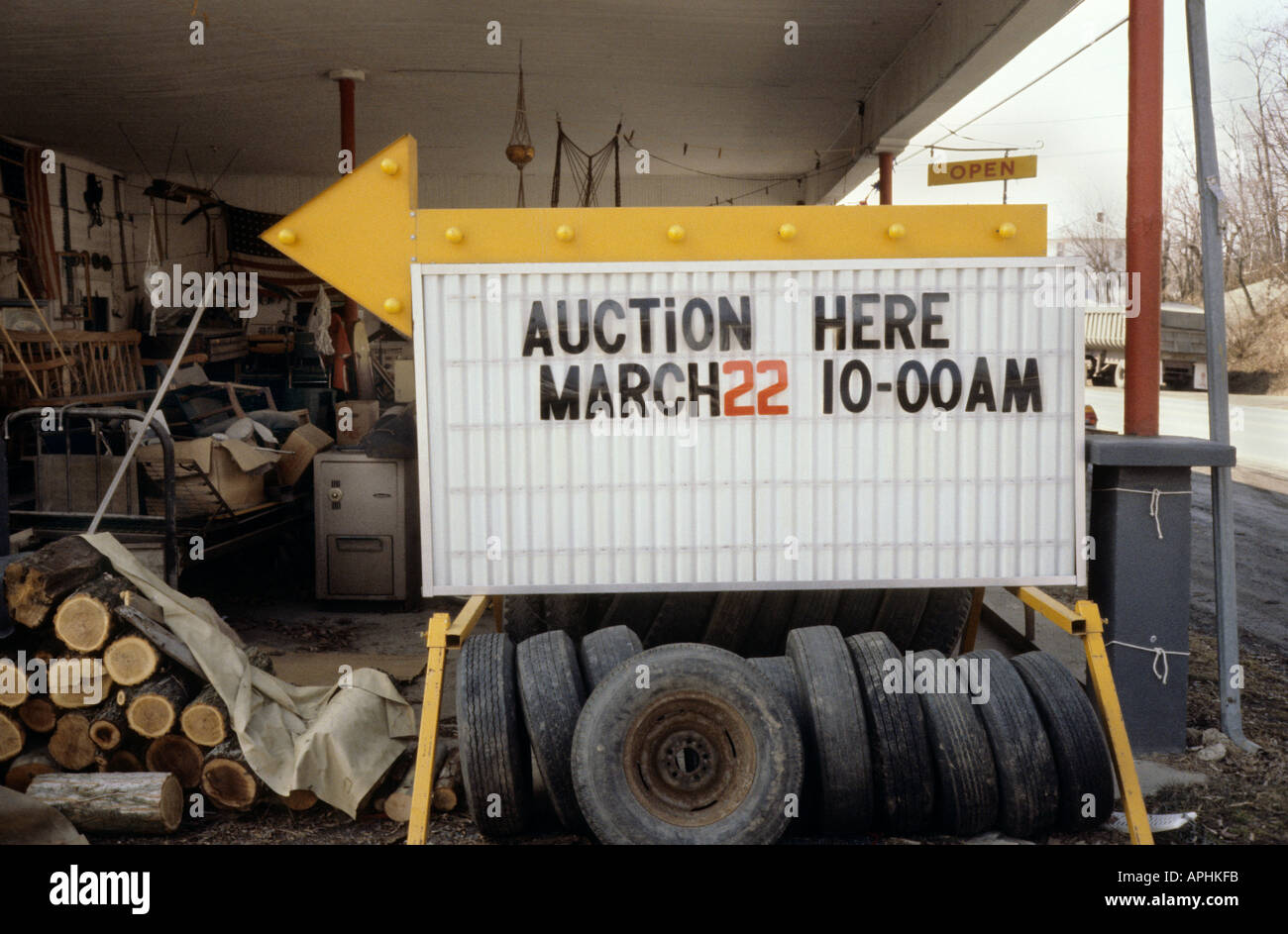 "Auction Here" sign in garage overhang Stock Photo - Alamy
