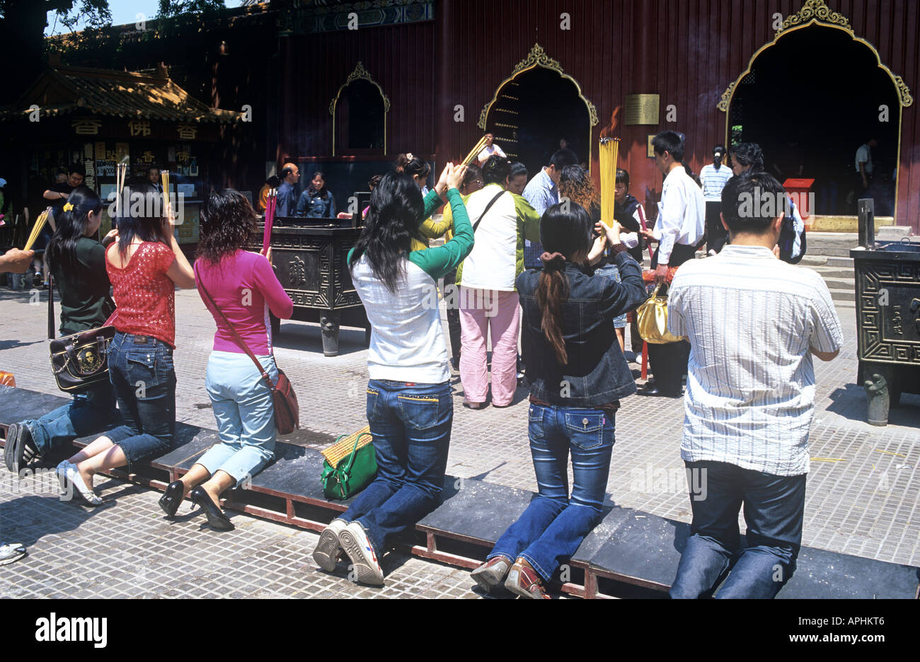 Praying people with incense in front of Small Temple at the Lama Temple ...