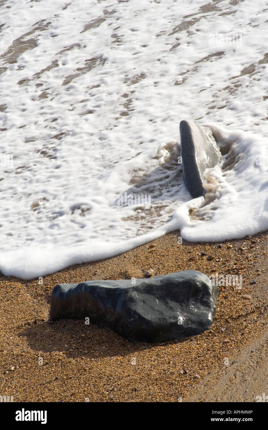 Wave against Rocks Stock Photo - Alamy
