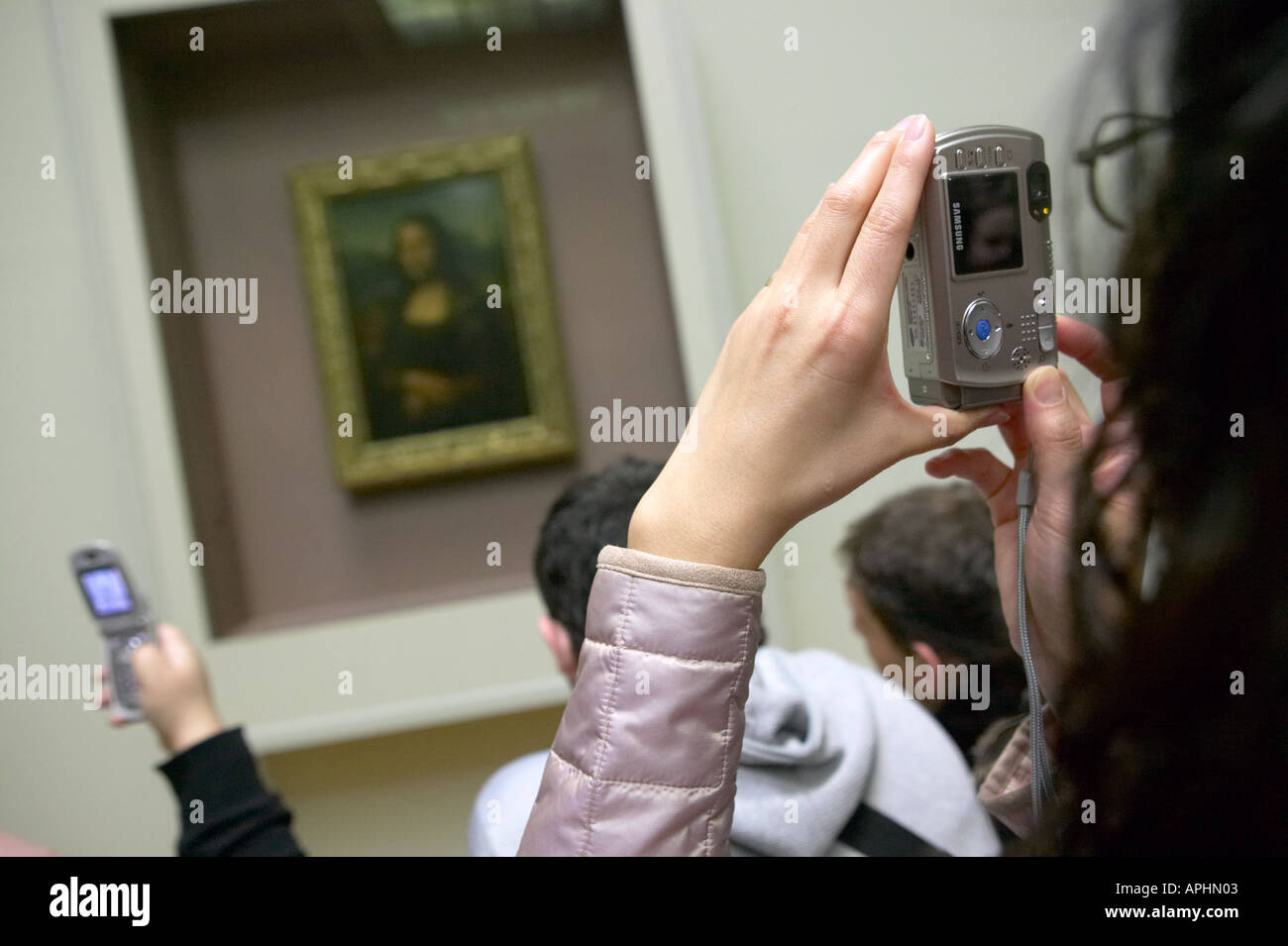 Tourists take pictures of the Mona Lisa with there digital cameras in ...