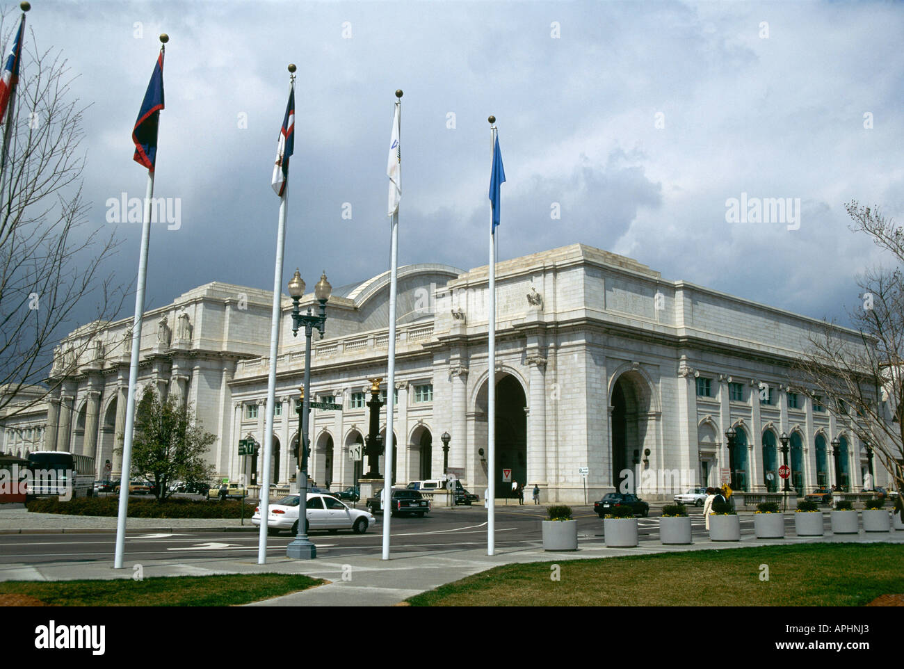 Trees fringing and flags flying above the Doric facade of the Beaux ...