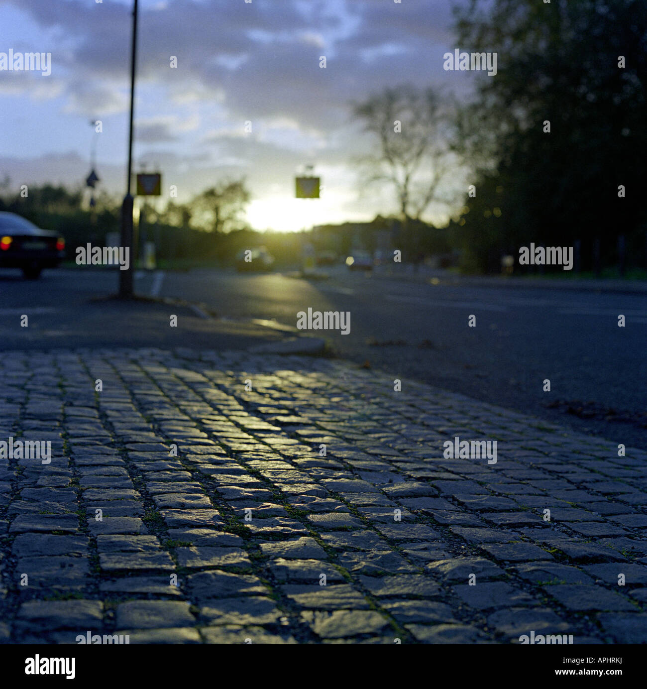 a cobbled street at sunset in a uk street Stock Photo - Alamy