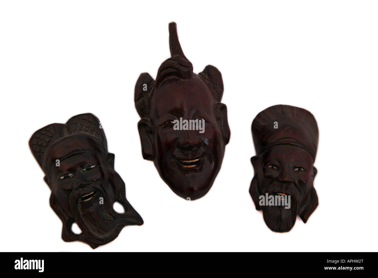 Three Carved mens faces Stock Photo - Alamy