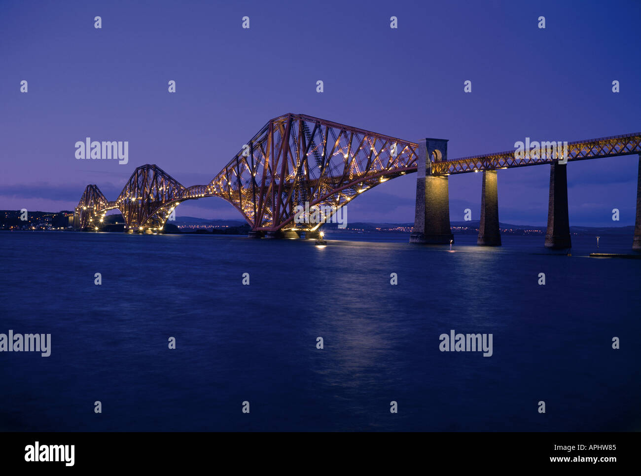 Forth Rail Bridge illuminated at night over the Firth of Forth ...