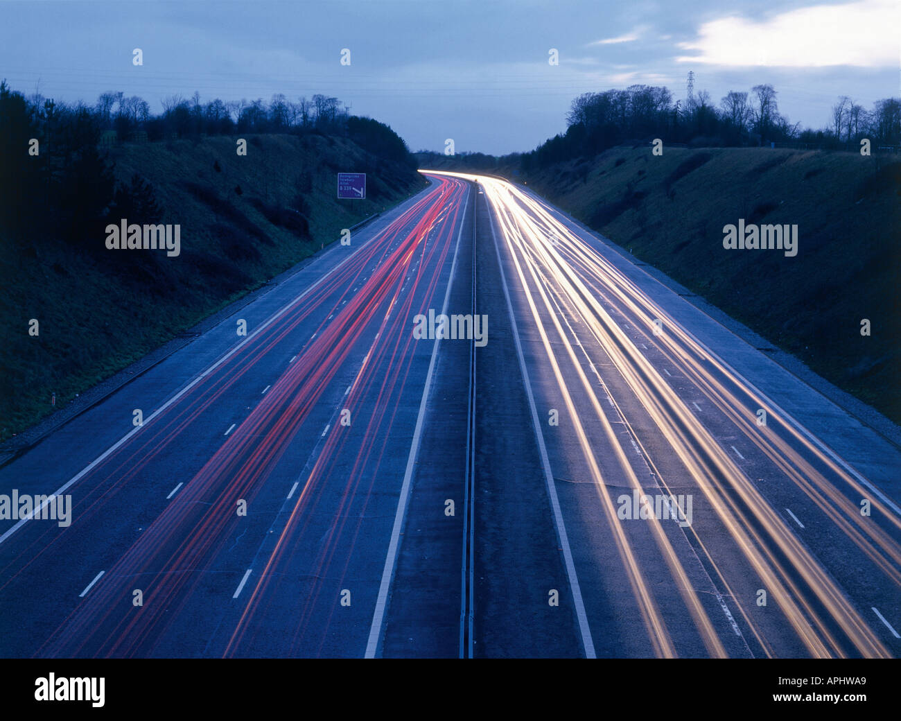 Red and white lines of lights of cars driving along the M3 motorway at ...