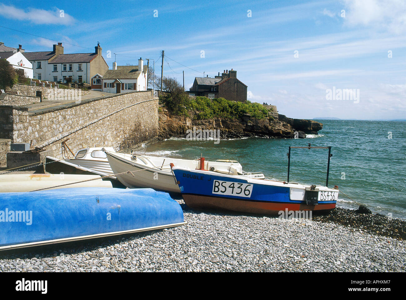 Boats drawn up on the shingle at Meolfre beach Anglesey Stock Photo - Alamy