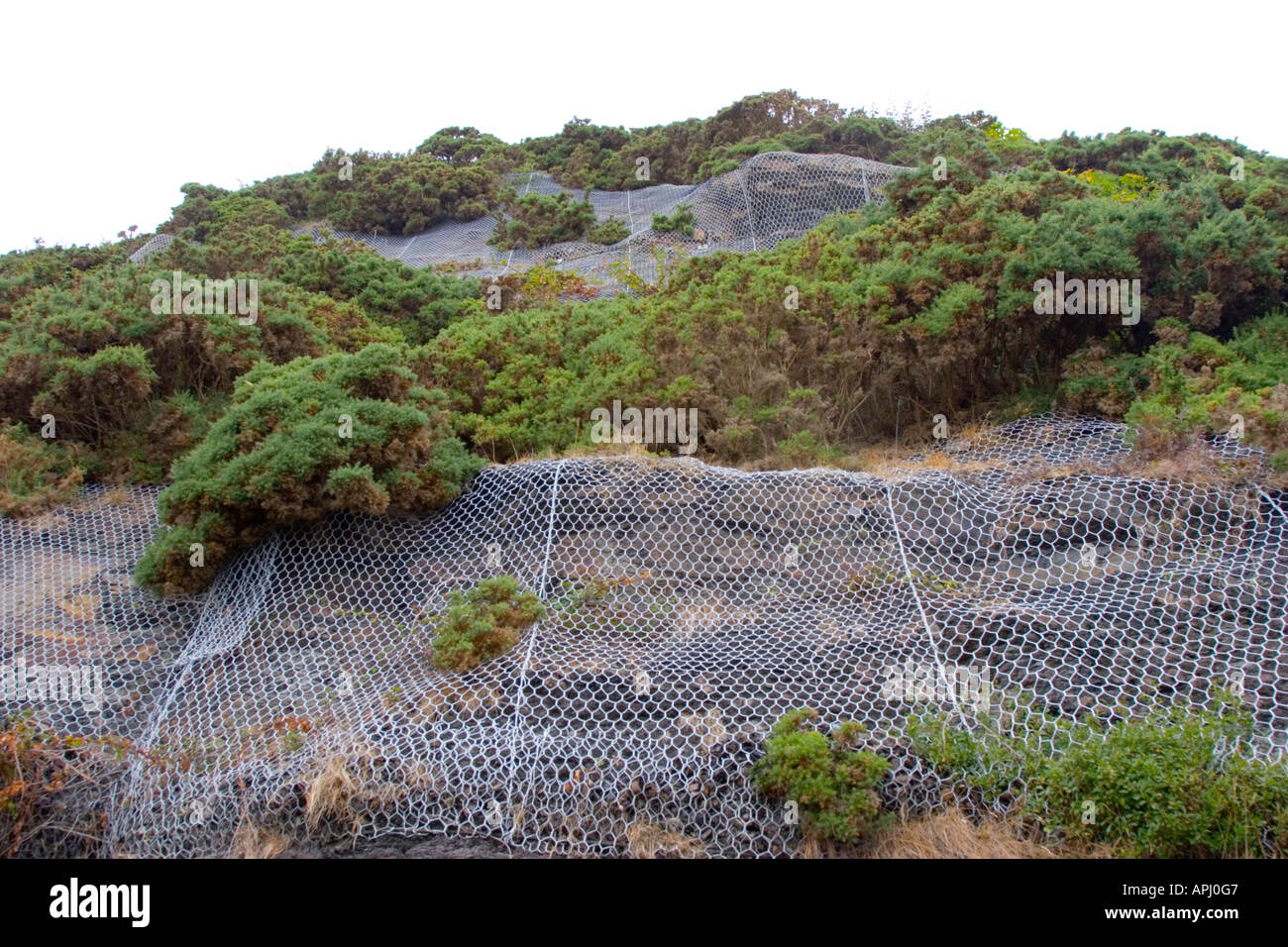Wire mesh used to stop rock falls from unstable cliff Stock Photo - Alamy