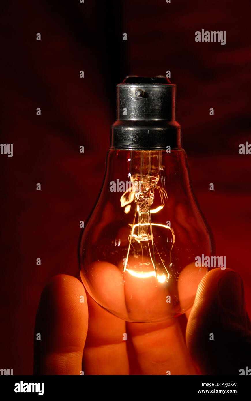 fingers holding a light bulb Stock Photo - Alamy