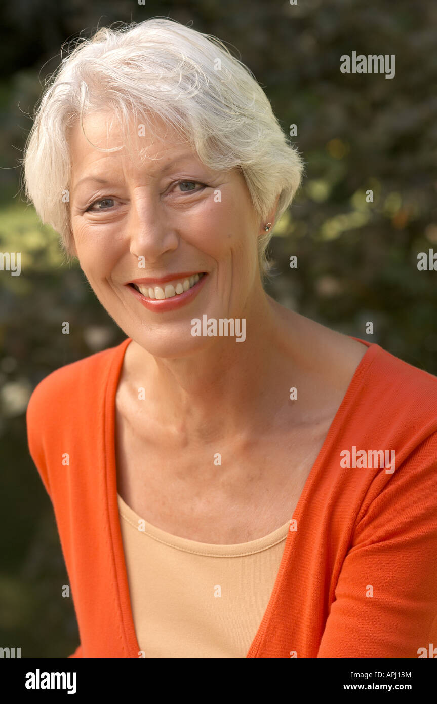 Smiling portrait of woman in her 60s looking straight at camera Stock ...