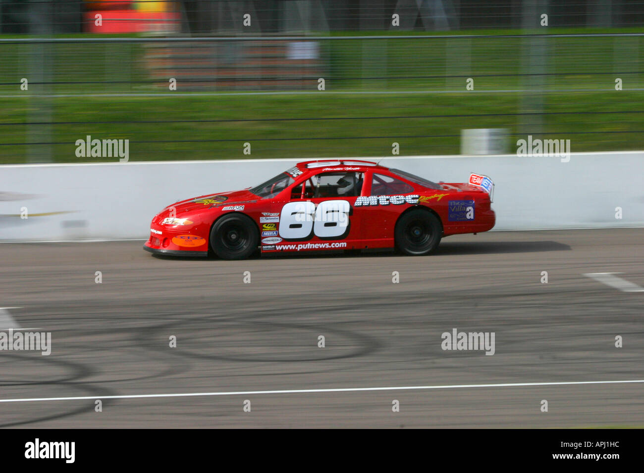 V8 Nascar type stock cars racing on a banked oval circuit Stock Photo ...