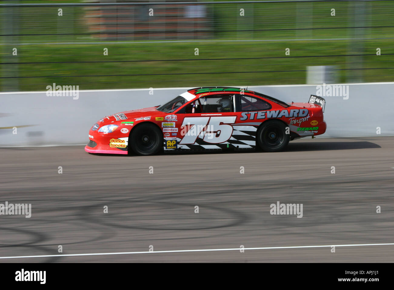 V8 Nascar type stock cars racing on a banked oval circuit Stock Photo ...
