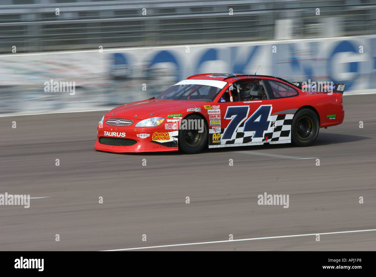 V8 Nascar type stock cars racing on a banked oval circuit Stock Photo ...