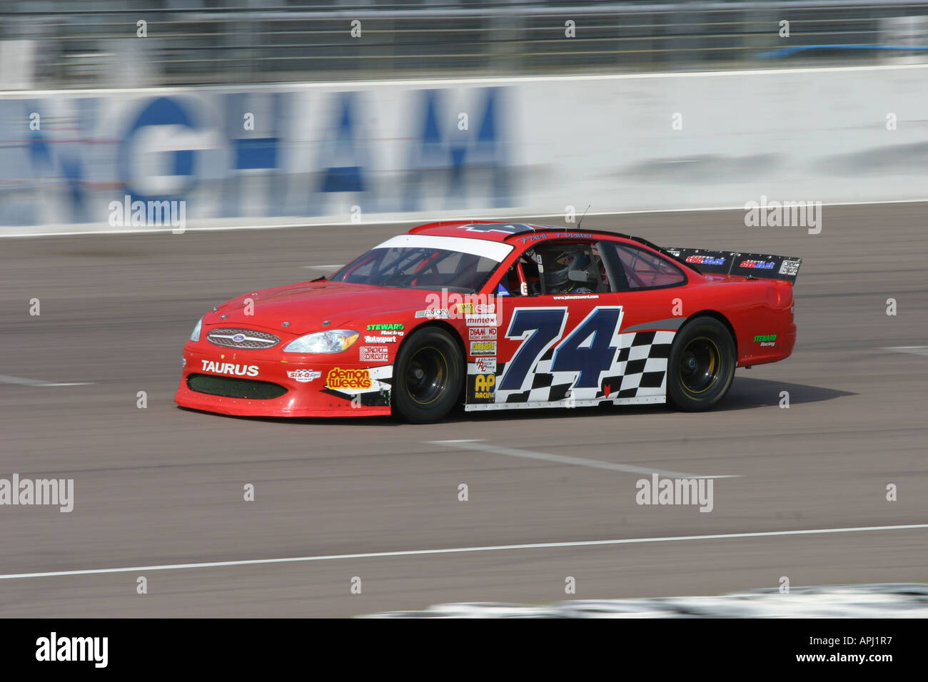 V8 Nascar type stock cars racing on a banked oval circuit Stock Photo ...