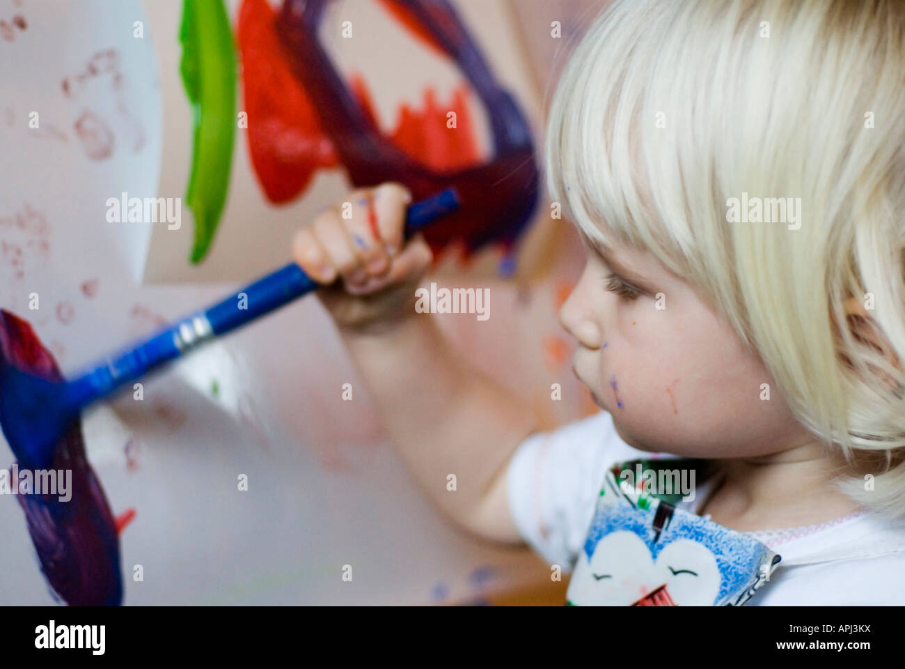 Stock Photo of a two year old child painting a picture She is using a ...