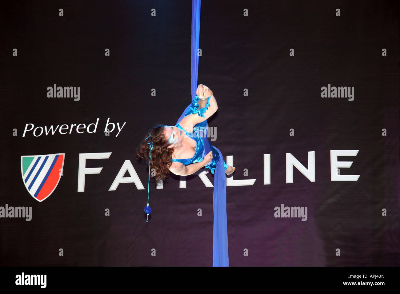 Aerial flyers slide on silk ropes on the main stage powered by Fairline ...