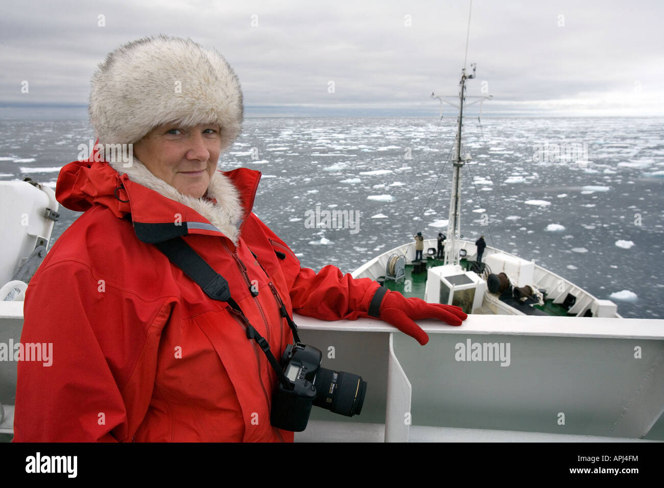 Adventure tourists on an polar icebreaker off the coast of Greenland ...