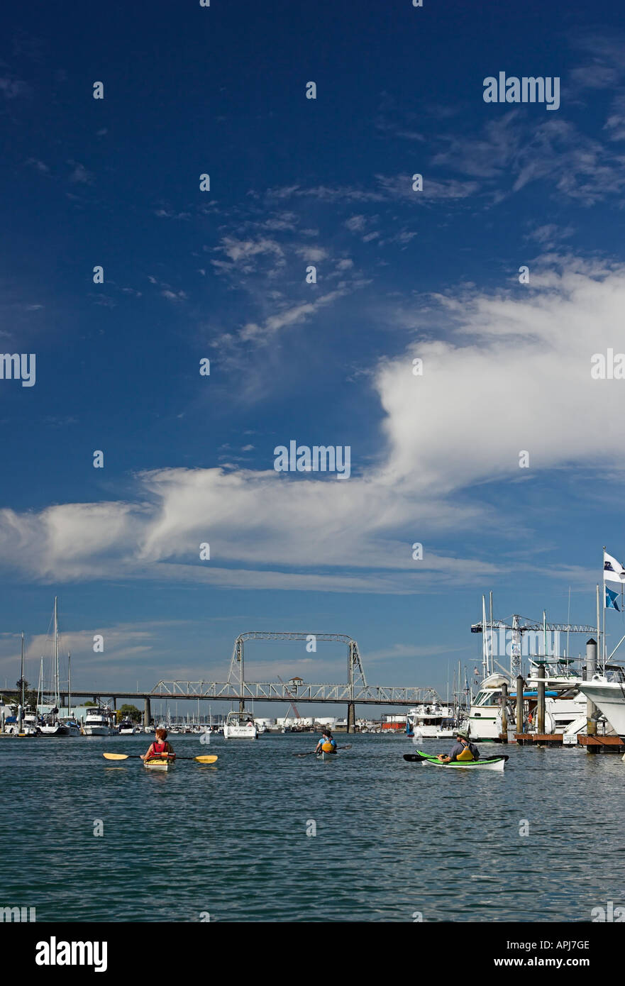 "Three kayakers ply the waters of the Thea Foss Waterway in the heart ...