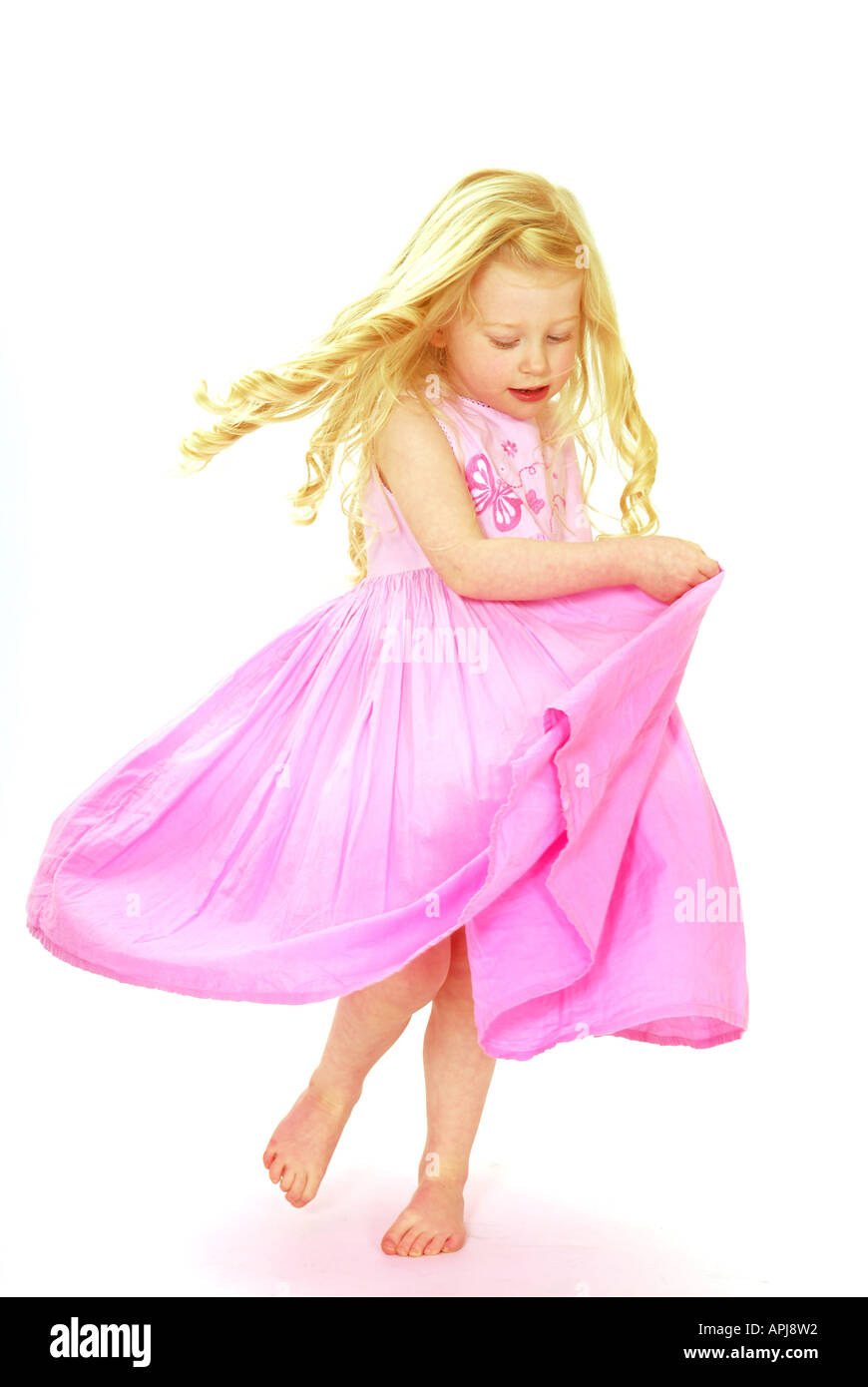 Girl playing in a pink dress Stock Photo - Alamy