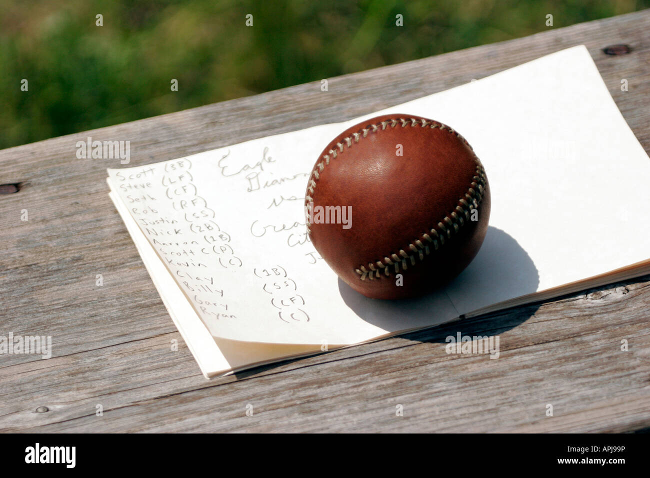 Baseball and roster of the players at a vintage baseball game in a play ...