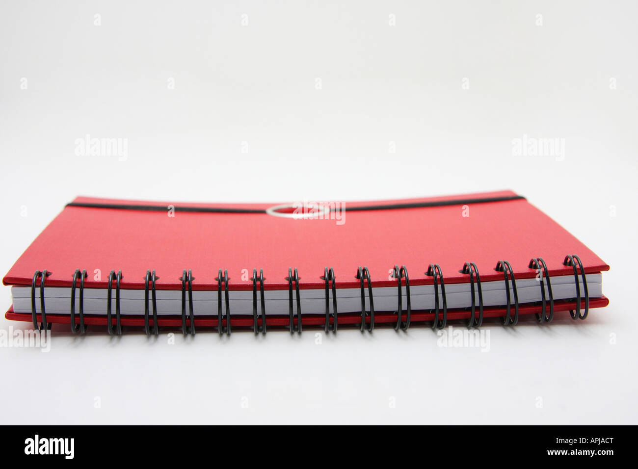 Red notebook lying closed on white Stock Photo - Alamy