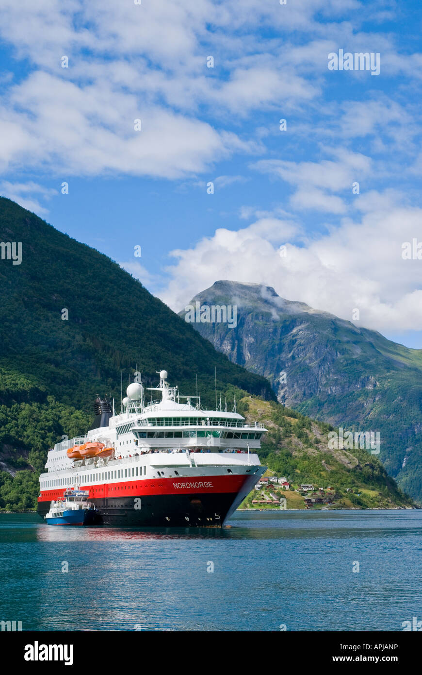 Hurtigruten passenger ferry at port in Geiranger and surrounded by the ...