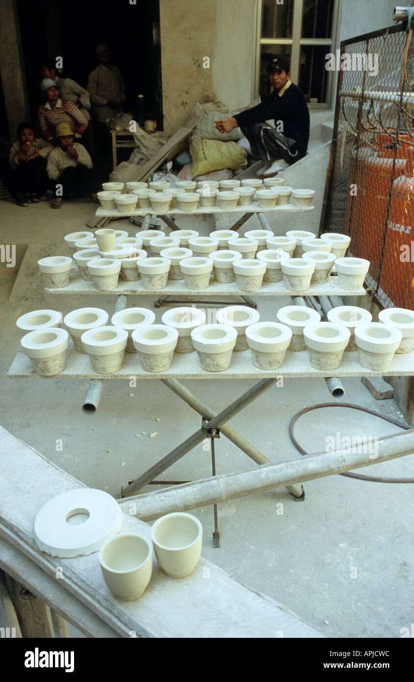 Clay moulds for forming cups in a pottery workshop, Bat Trang pottery ...