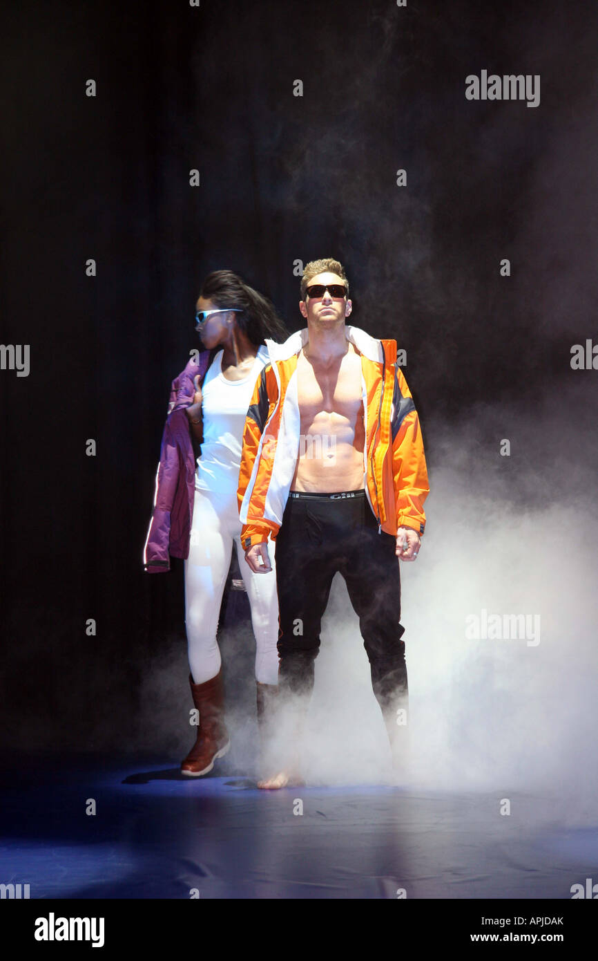 Male model on the catwalk modelling an orange waterproof jacket with a ...