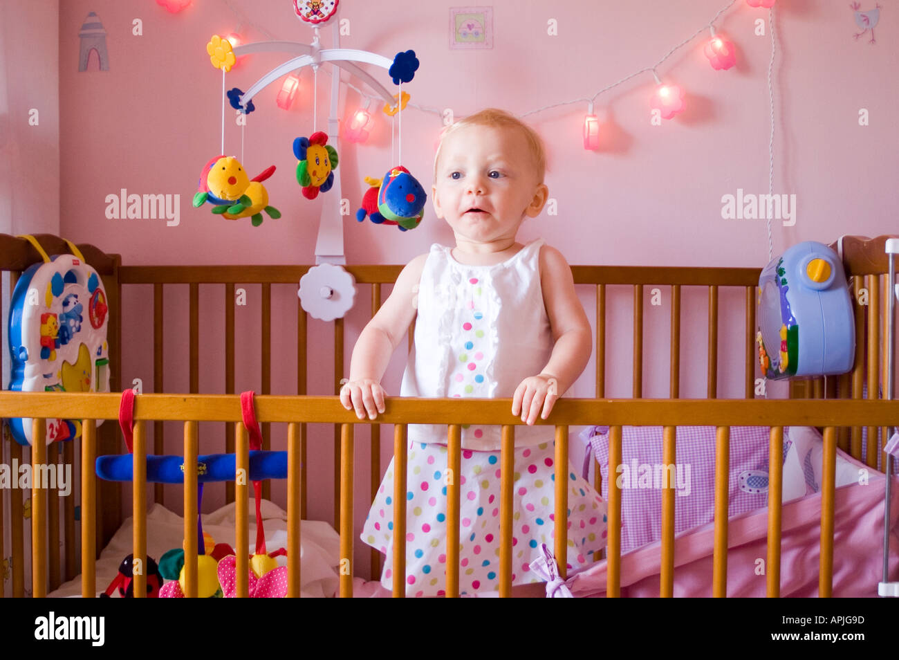 Baby in cot and bedroom Stock Photo - Alamy