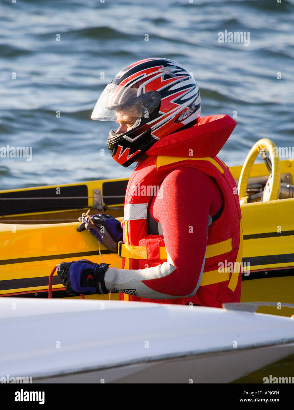 Powerboat Racer preparing to board his race boat Stock Photo - Alamy