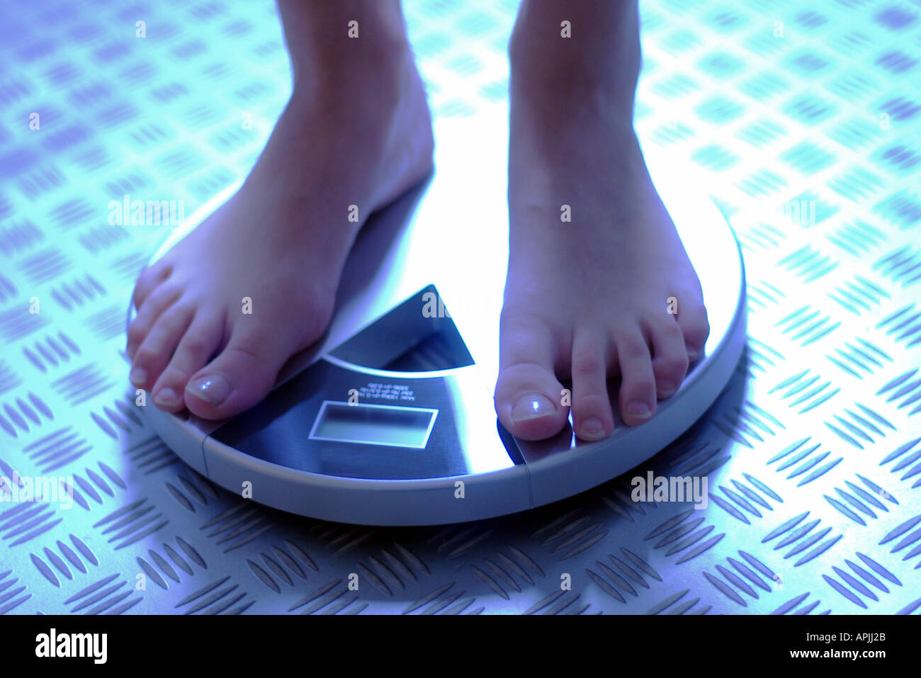 Standing on Bathroom Scales Stock Photo - Alamy