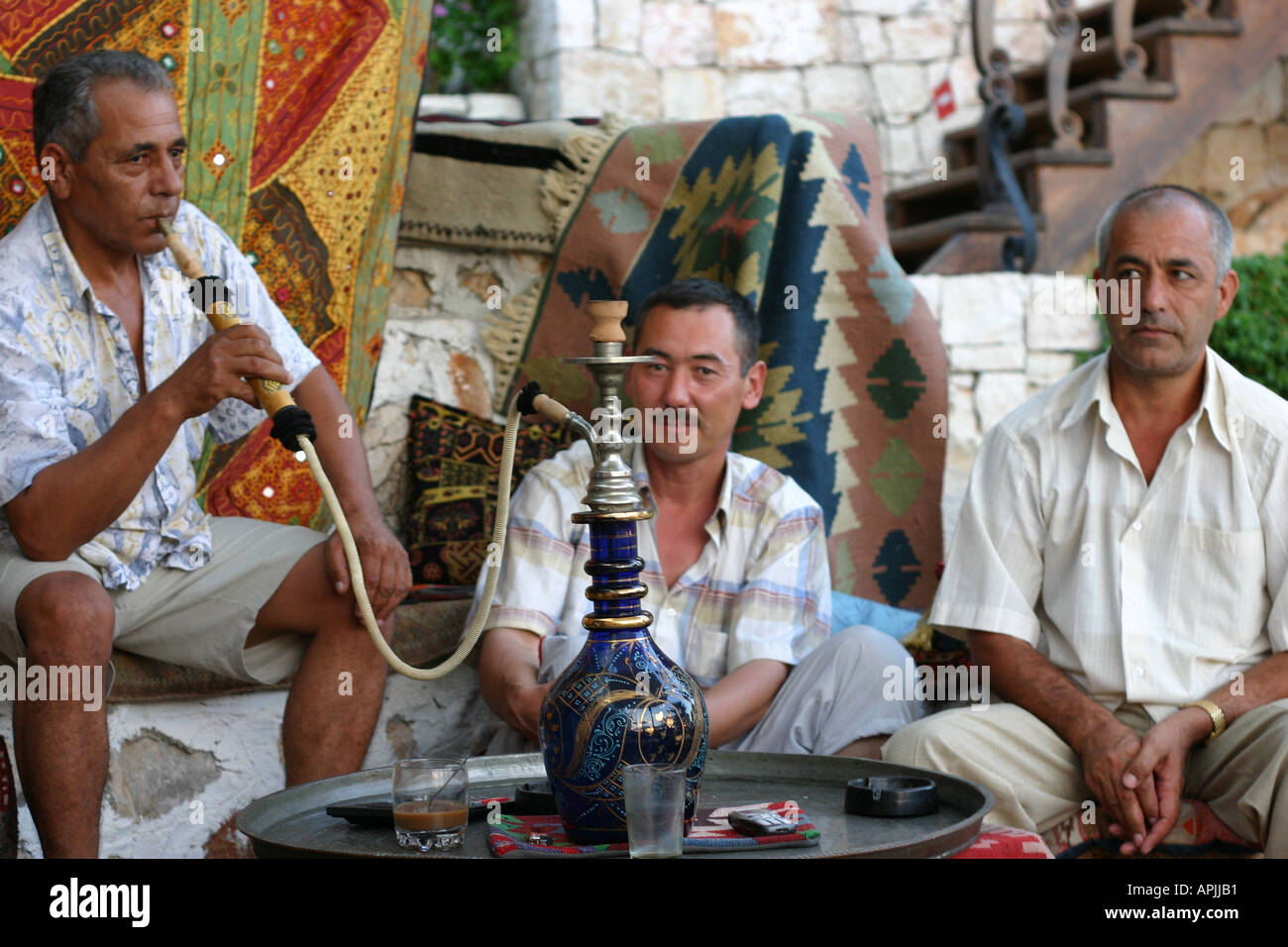 Smoking out of a nargile, also called hookah, and chatting is one of ...