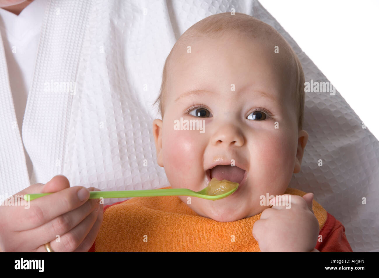 Baby is fed with a spoon Stock Photo - Alamy