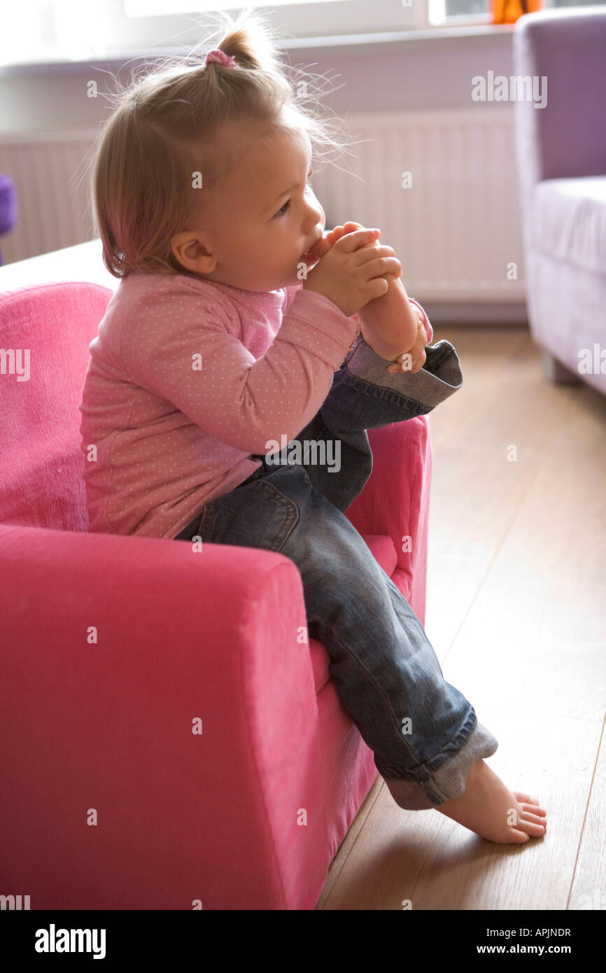 Little girl sucking her toe Stock Photo - Alamy