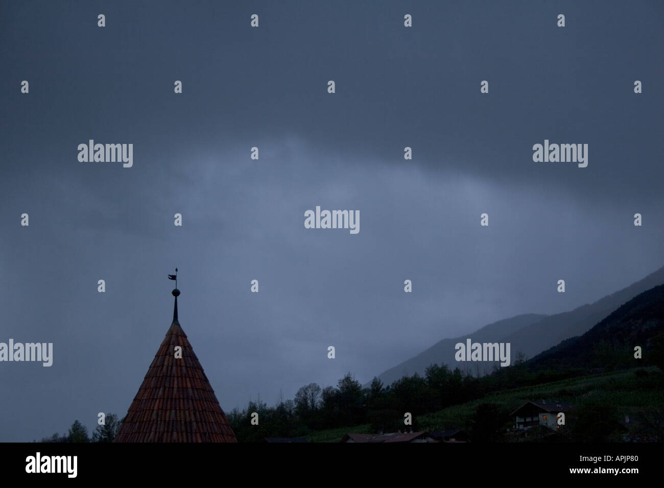 Thunder clouds and rain approaching round turret tower of castle ...