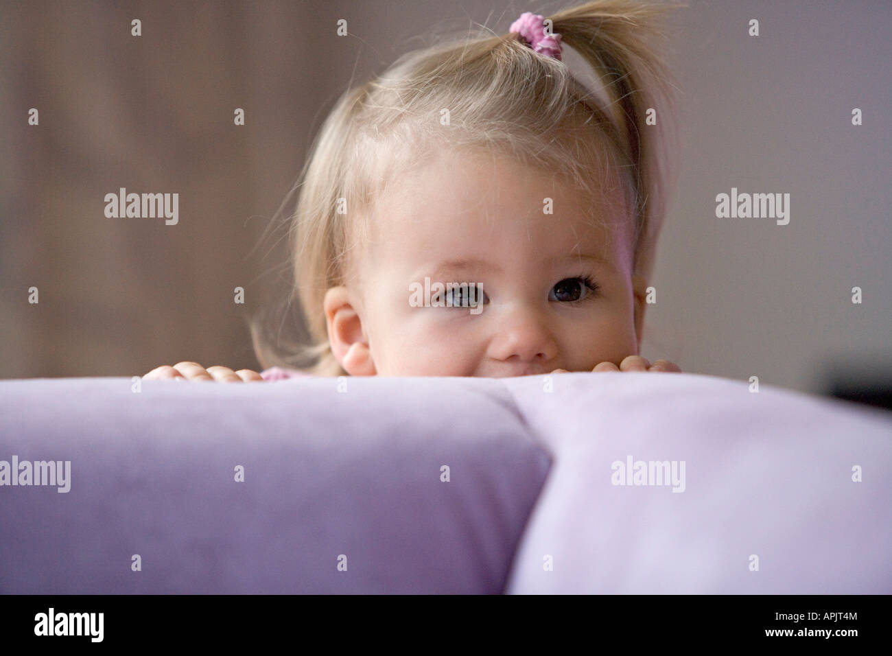 Little girl hiding behind the couch Stock Photo - Alamy Little girl hiding behind the couch Stock Photo - Alamy