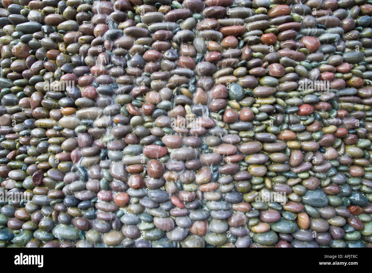 Polished River Stones with Water Fountain Stock Photo - Alamy