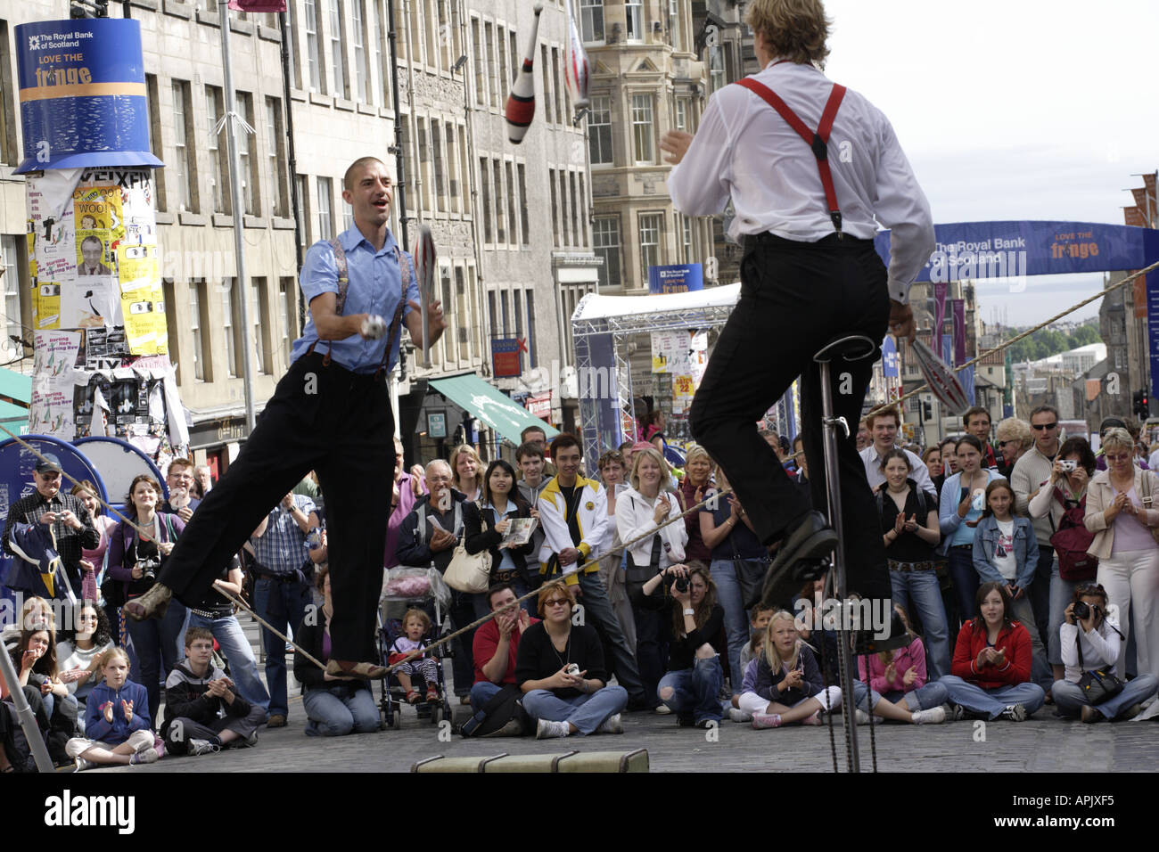 Two jugglers on tight rope and unicycle Stock Photo - Alamy