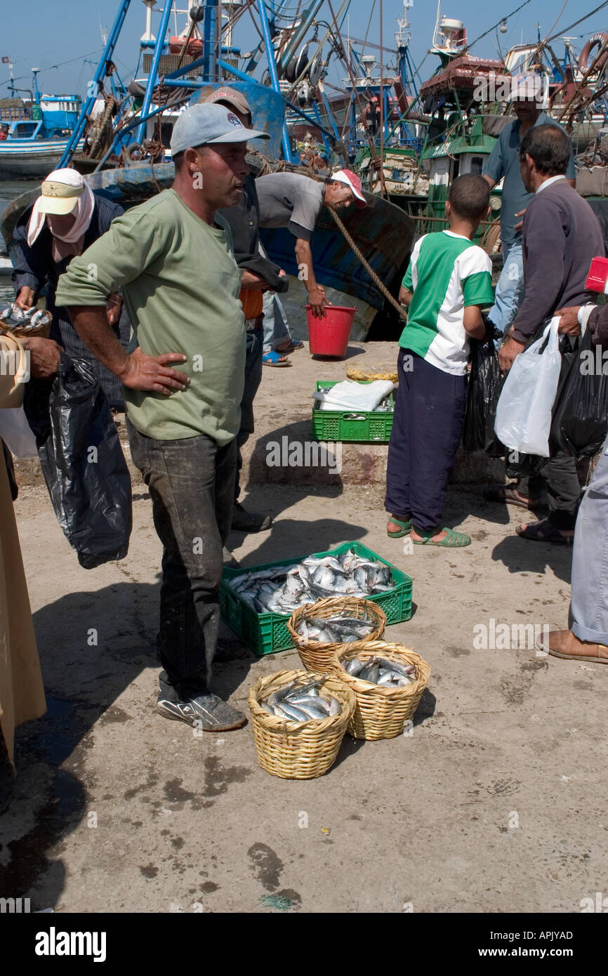 fisherman selling recently landed fish on quayside Stock Photo - Alamy