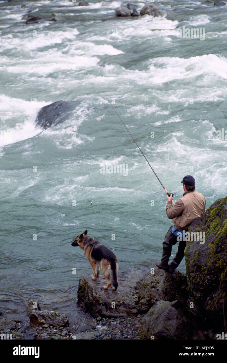 Fisherman and Dog fishing in River Stock Photo - Alamy