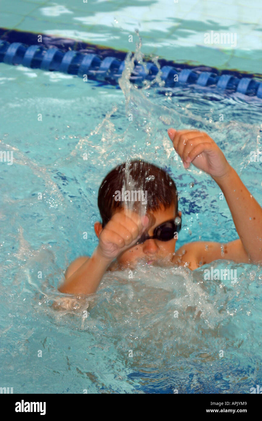 Young boy splashing in a swimming pool Stock Photo - Alamy